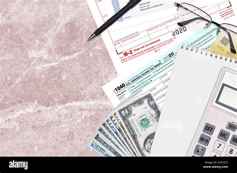 Irs Form 1040 Individual Income Tax Return And W 2 Wage And Tax Statement Lies On Office Table