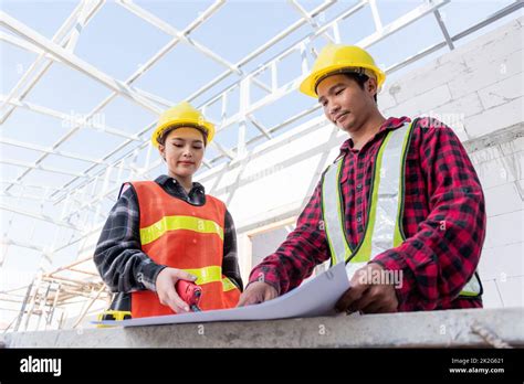 Architect And Client Discussing Help Create Plan With Blueprint Of The