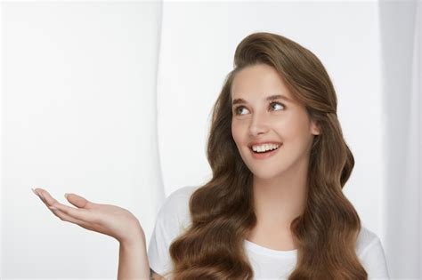 Cute Girl Holds An Arm For Copy Space Smiling Premium Photo