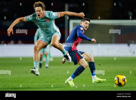 Barcelonas Robert Lewandowski Right And Atletico Madrids Marcos Llorente During The Spanish