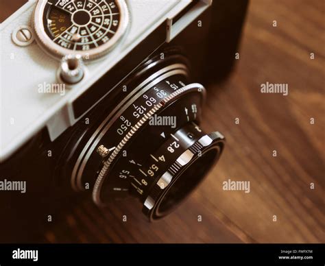 Close Up Photo Of Old Vintage Camera Lens Over Wooden Table Selective