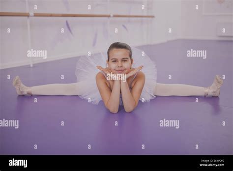 Cute Happy Young Ballerina Doing Splits Smiling To The Camera