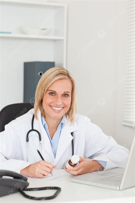 Physician Jotting Notes And Examining Medication Vial Treatment Exam Smile Photo Background And