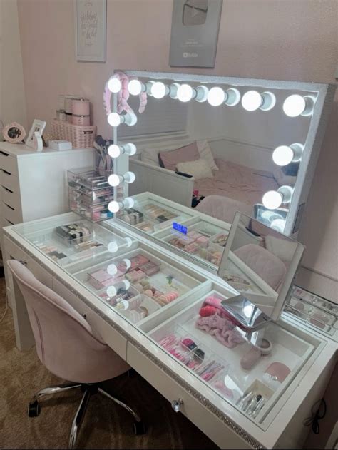 White Vanity With Lights And Bed In Background