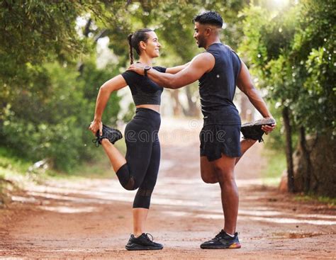 Young Fit Couple Exercising Outdoors Together Bonding While Stretching