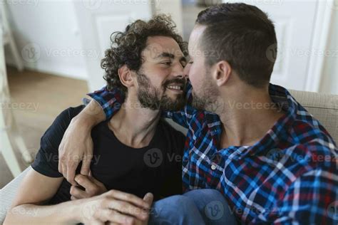 Cheerful Young Gay Couple Sitting Together Two Affectionate Male Lovers Smiling Cheerfully