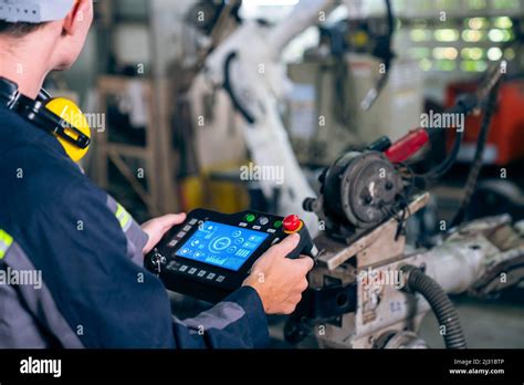 Young Factory Worker Working With Adept Robotic Arm In A Workshop Industry Robot Programming