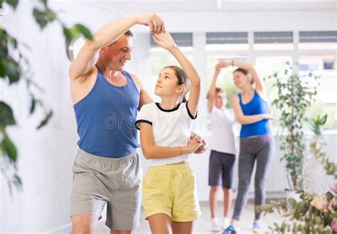 Cheerful Middle Aged Man Practicing Active Dance In Pair With His Tween