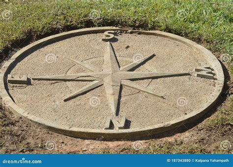Stone Compass Rose Set Within A Star Golden Coloured Paving Slabs
