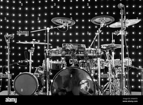 Drum Kit With Different Types Of Drums On The Stage With Lights On The Background In Black And