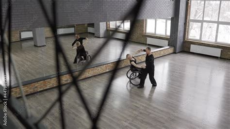 Top View Of Elegant Dance Partners Handicapped Woman On Wheelchair And