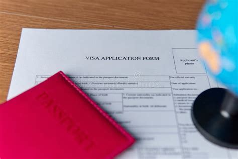 A Visa Application Form A Red Passport And A Globe Stock Image