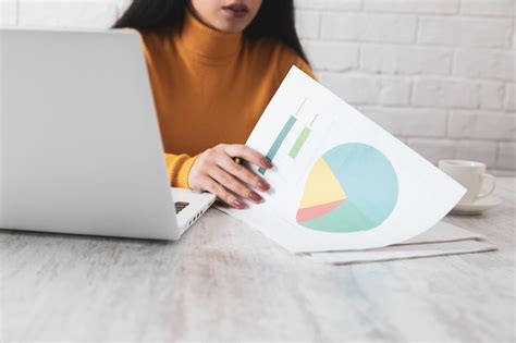 Premium Photo Woman Hand Graph With Computer On Table