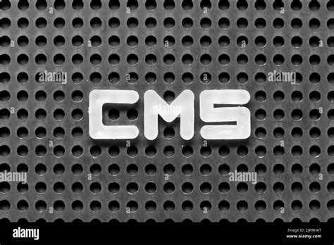 White Alphabet Letter In Word Cms Abbreviation Of Content Management System On Black Pegboard