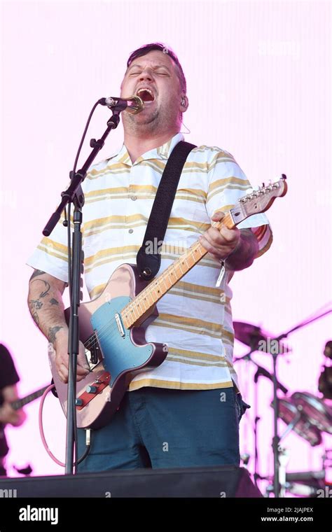 Singer Songwriter And Guitarist Isaac Brock Is Shown Performing On Stage During A Live Concert