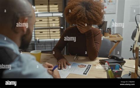 A Stressed Woman With A Detective In An Indoor Investigation Office