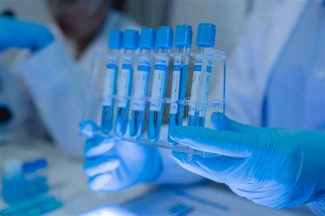 When In A Lab Scientists Wear Lab Coats Rubber Gloves And Safety Goggles Two Chemists Are