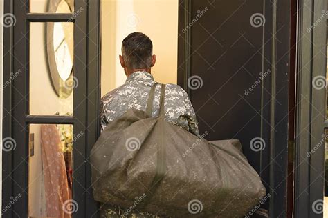 Caucasian Male Soldier In Uniform Returning Home Walking Into House