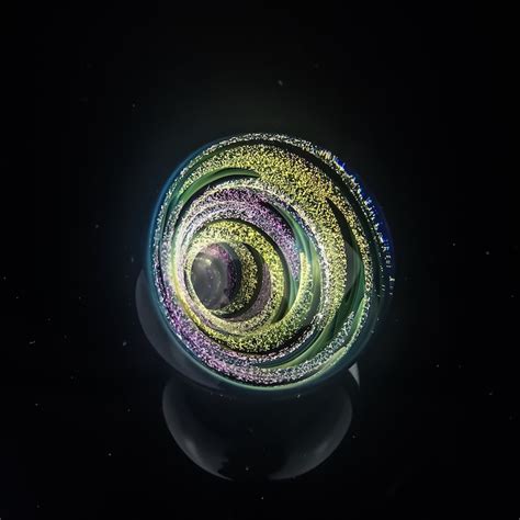 Artist Embeds Never Ending Vortexes Into Art Glass Marbles