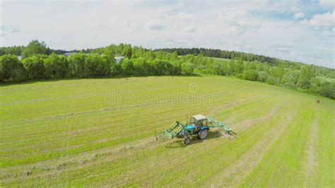 Tractor Collects Hay On Grass Field At Summer Stock Video Video Of