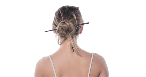 Premium Photo A Woman Makes A Messy Hair Bun On Her Head
