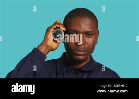 Headshot Portrait Of Security Employee Tasked With Evicting Trespassers Turning On Flashlight