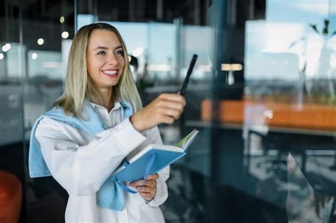 Premium Photo Blonde Businesswoman Writing Something On A Glass Board
