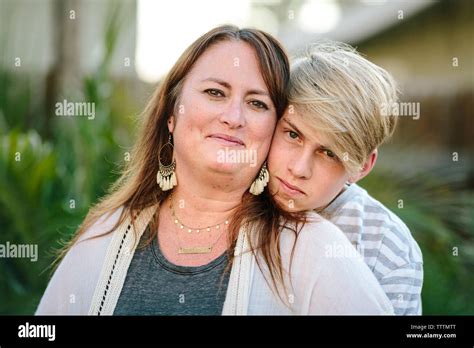 Portrait Of Son Embracing Mother While Standing At Yard Stock Photo Alamy