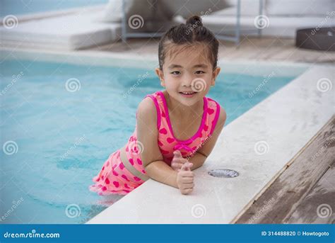 Portrait Girl In Pink Swimsuit Playful In Swimming Pool Summer Time