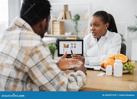 Dietitian Analyzing Data on Tablet with Patient in Clinic Stock Image - Image of infographics ...