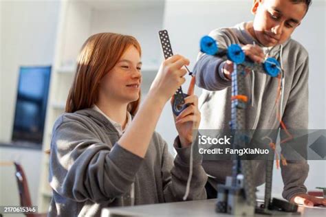 Teenage Girl In High School Classroom Making Physics Construction Science Engineering Technology