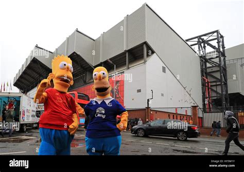 Fans Dressed As Bart And Homer Simpson Before The Premier League Match