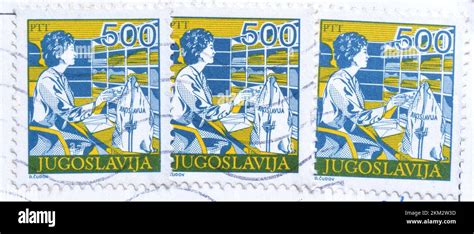 Cancelled Postage Stamp Printed By Yugoslavia That Shows Postal Worker