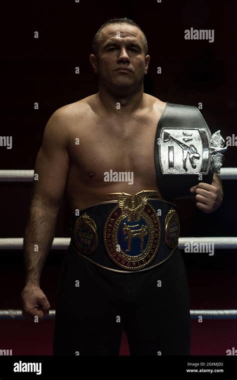 Portrait Of Muscular Professional Kick Boxer With His Championship Belt