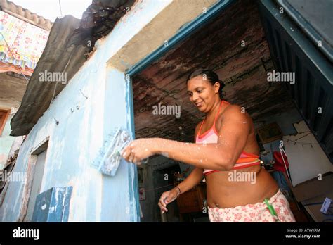 A Woman Paints Her Favela House Rio De Janeiro Brazil South America Part Of A Charity