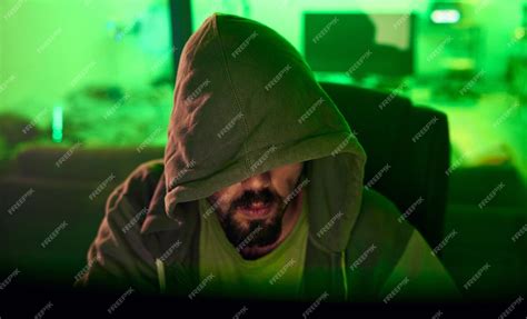 Premium Photo Computer Hacker Hoodie Or Neon Man Hacking Database
