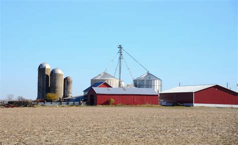 A Farm With A Red Barn And Silos Photo Free Nature Image On Unsplash