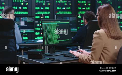 Beautiful Female Programmer Sitting At Desktop In Office With Servers Working Stock Video