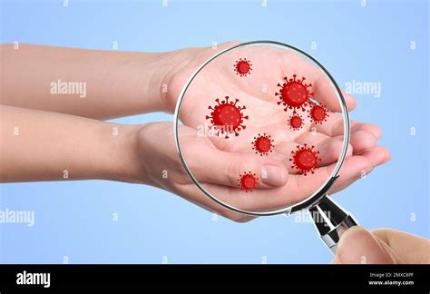 Woman Detecting Bacteria With Magnifying Glass On Blue Background