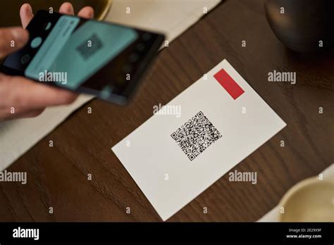 Cropped Photo Of Person Scanning A QR Code Of Restaurant Menu With Help Of Smartphone Stock