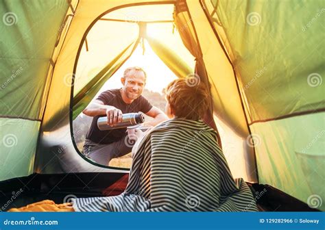 Father And Son Prepare For Camping In Mountain Drink Tea In Ten Stock
