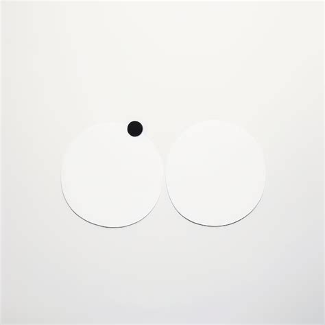 Premium Photo A White Background With Two Small Circles With Black Dot