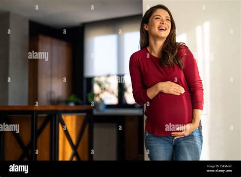 Fit Pregnant Woman Holding Hands On Her Belly Enjoying In The Last