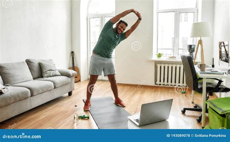 Personal Trainer Full Length Shot Of Male Fitness Instructor Stretching His Body While