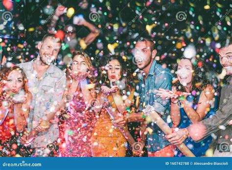 Happy Friends Doing Party Throwing Confetti In The Club Millennials