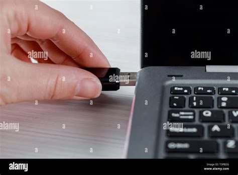 Female Hand Inserting USB Flash Drive And Laptop Stock Photo Alamy
