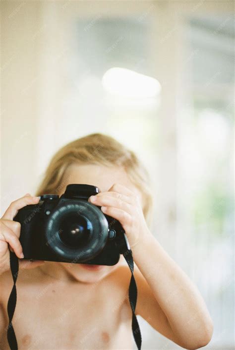 Young Nude Girl Taking A Picture With A Camera Premium Photo