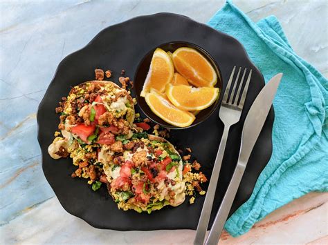 Tofu Sausage Scramble Florentine Over English Muffins And Orange Wedges