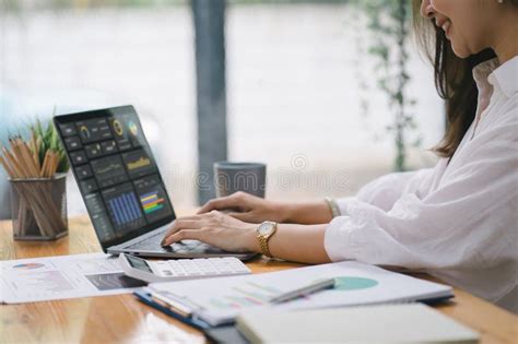 The Female Analyst Utilizes A Computer And A Dashboard For Business