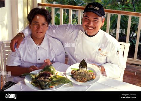 Chef Sam Choy Jr And His Son With Food He Prepared At A Hotel In
